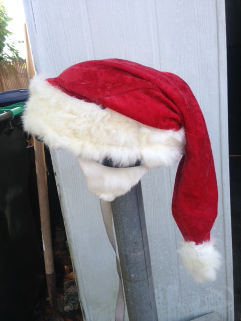 Santa turns his helmet into a custom Santa hat. – https://santabiker.com