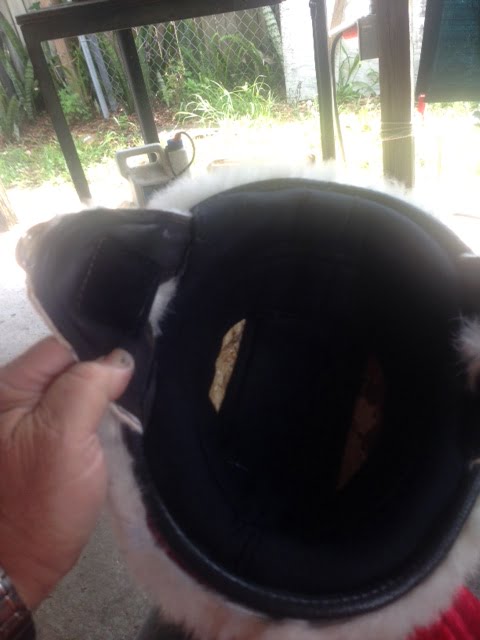 Santa turns his helmet into a custom Santa hat. – https://santabiker.com